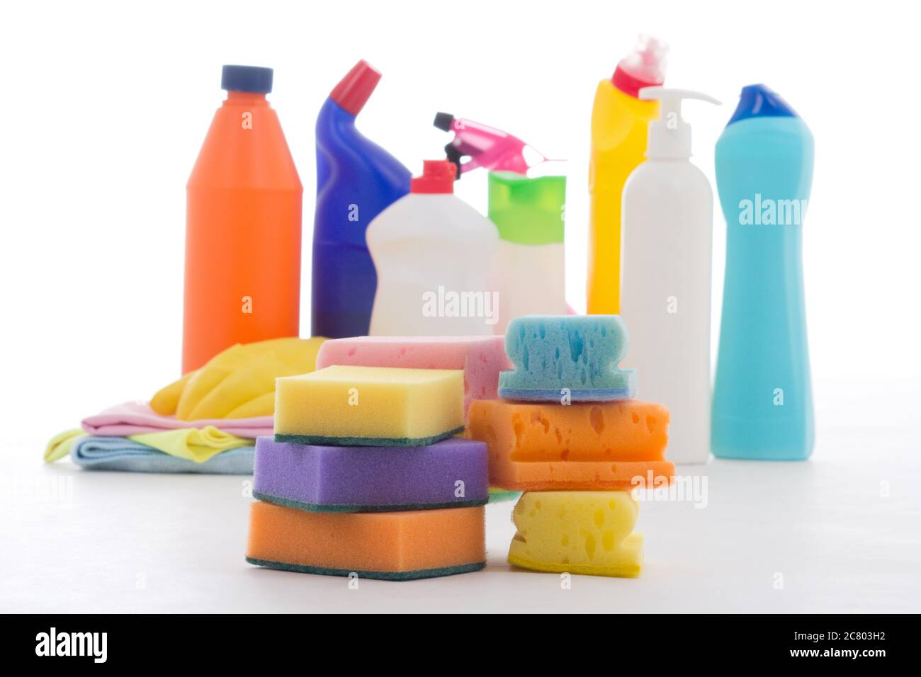 colorful plastic bottles of cleaning products and sponges isolated on ...