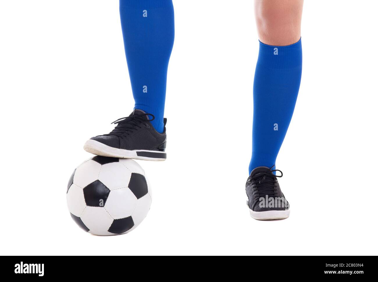 legs of soccer player and ball close-up isolated on white background ...