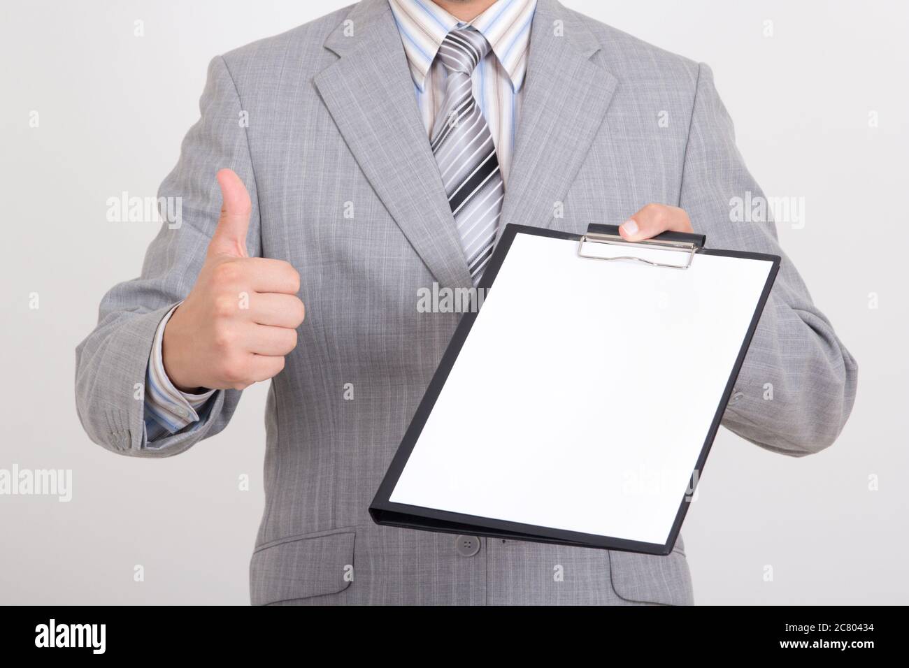 young business man with contract thumbed up Stock Photo - Alamy