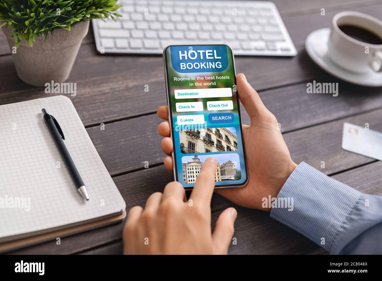 Smartphone with open hotel booking application in male hands Stock ...