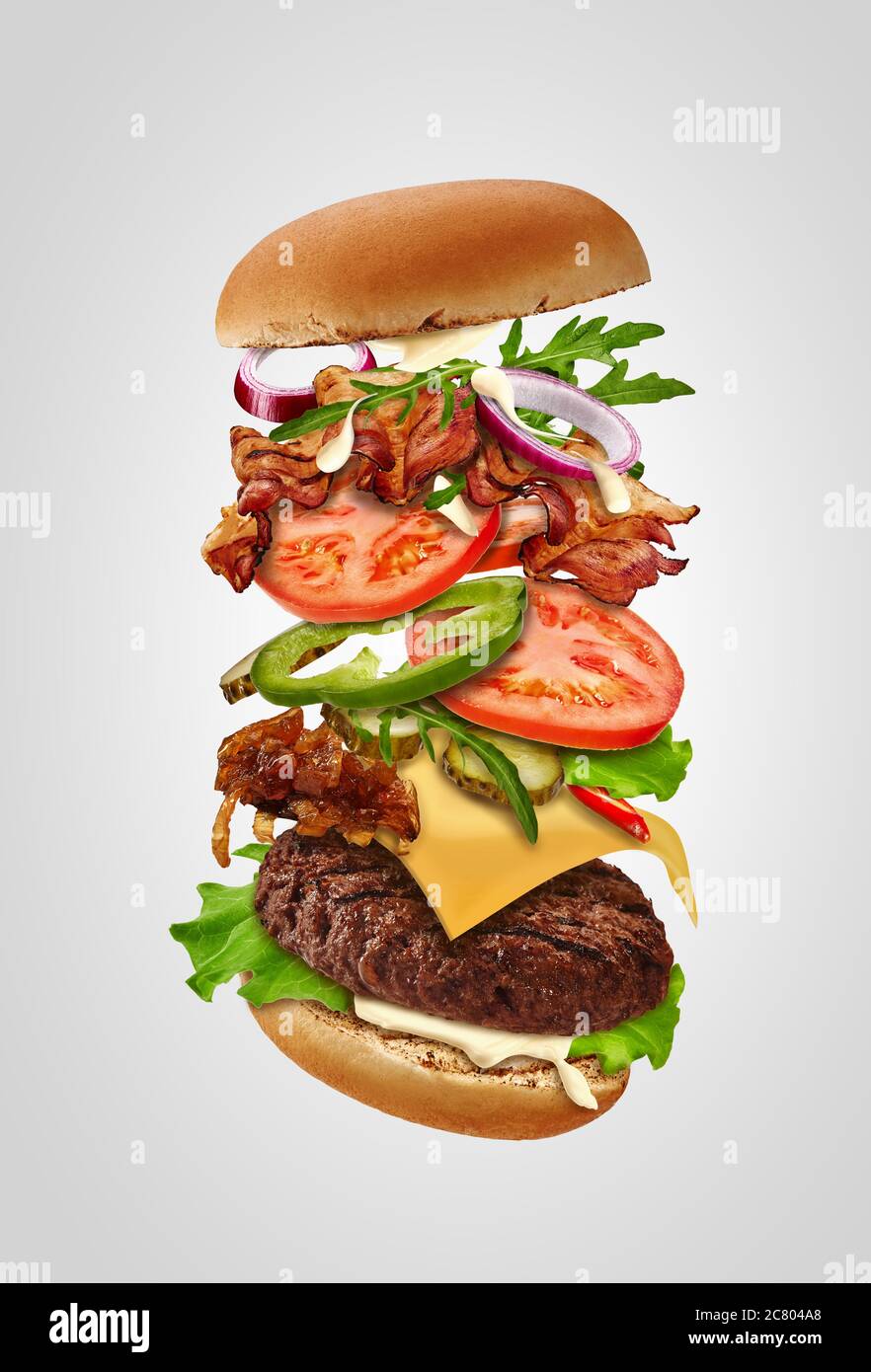 Big burger with flying ingredients against gray background. Ham, beef ...