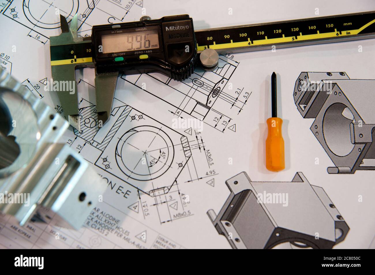 Metal tooling shop floor concept with CAD blueprint and micrometer ...
