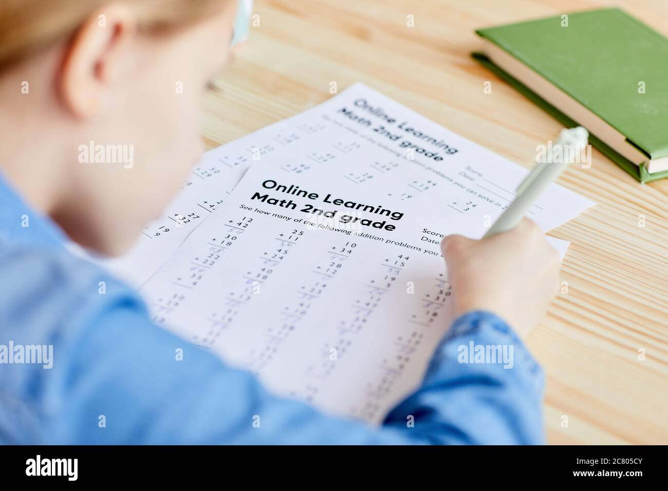 High angle close up of unrecognizable little girl doing math test for ...
