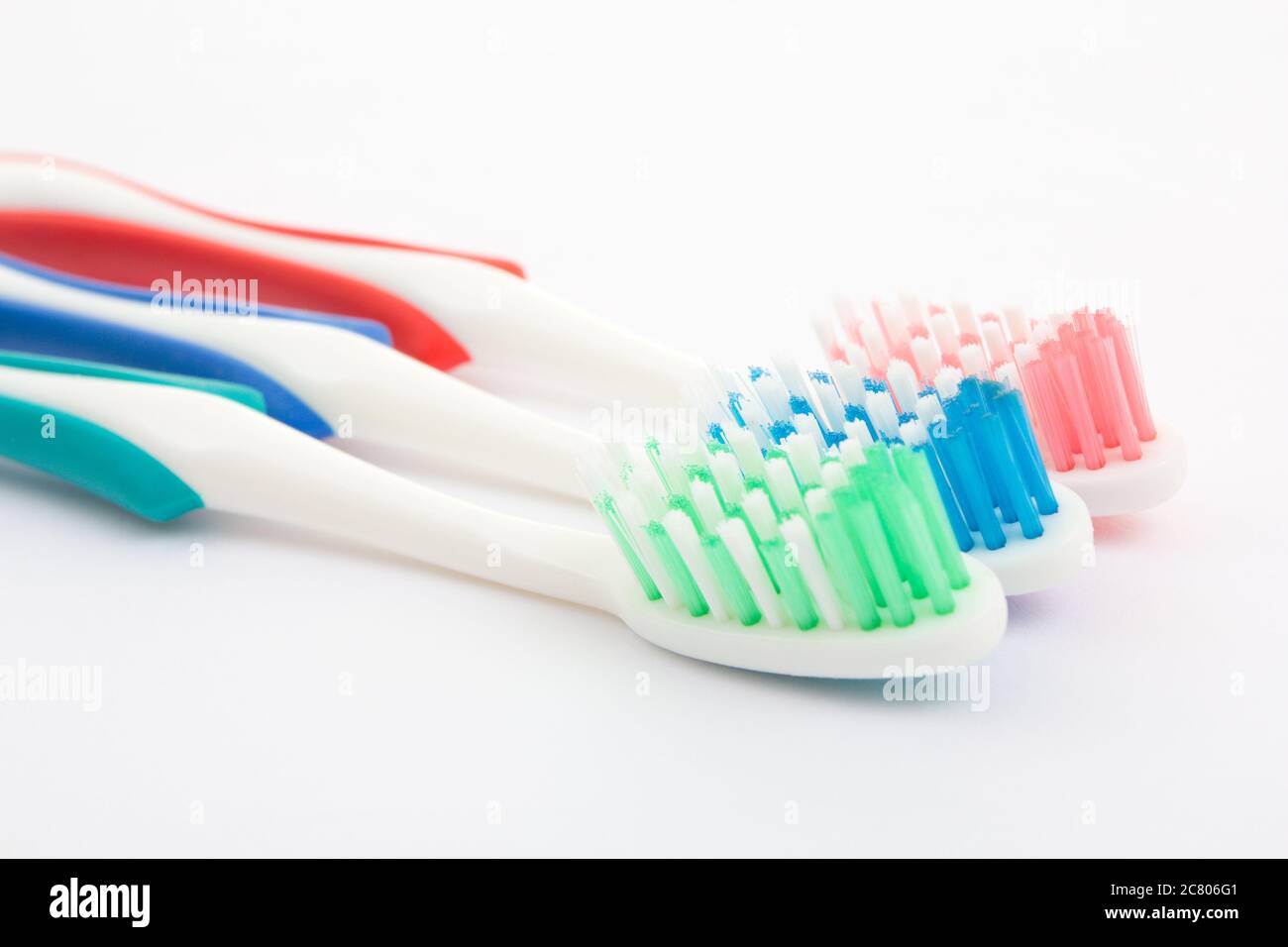 Red, green and blue toothbrush over white Stock Photo - Alamy