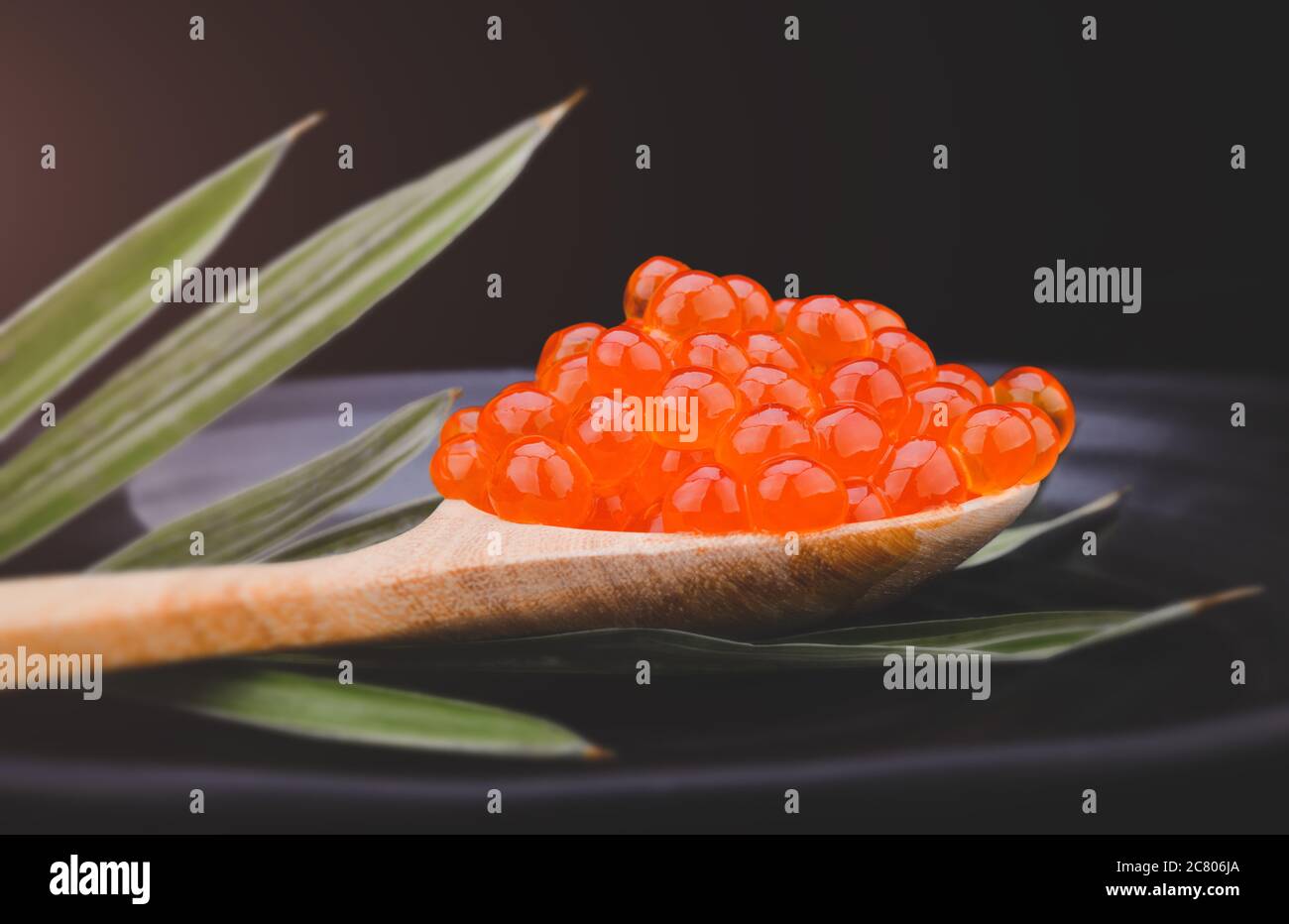 Salmon roe group with low lighting and black background Stock Photo - Alamy