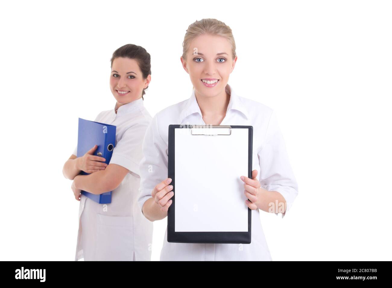 two young beautiful nurses with folders over white. copyspace Stock ...