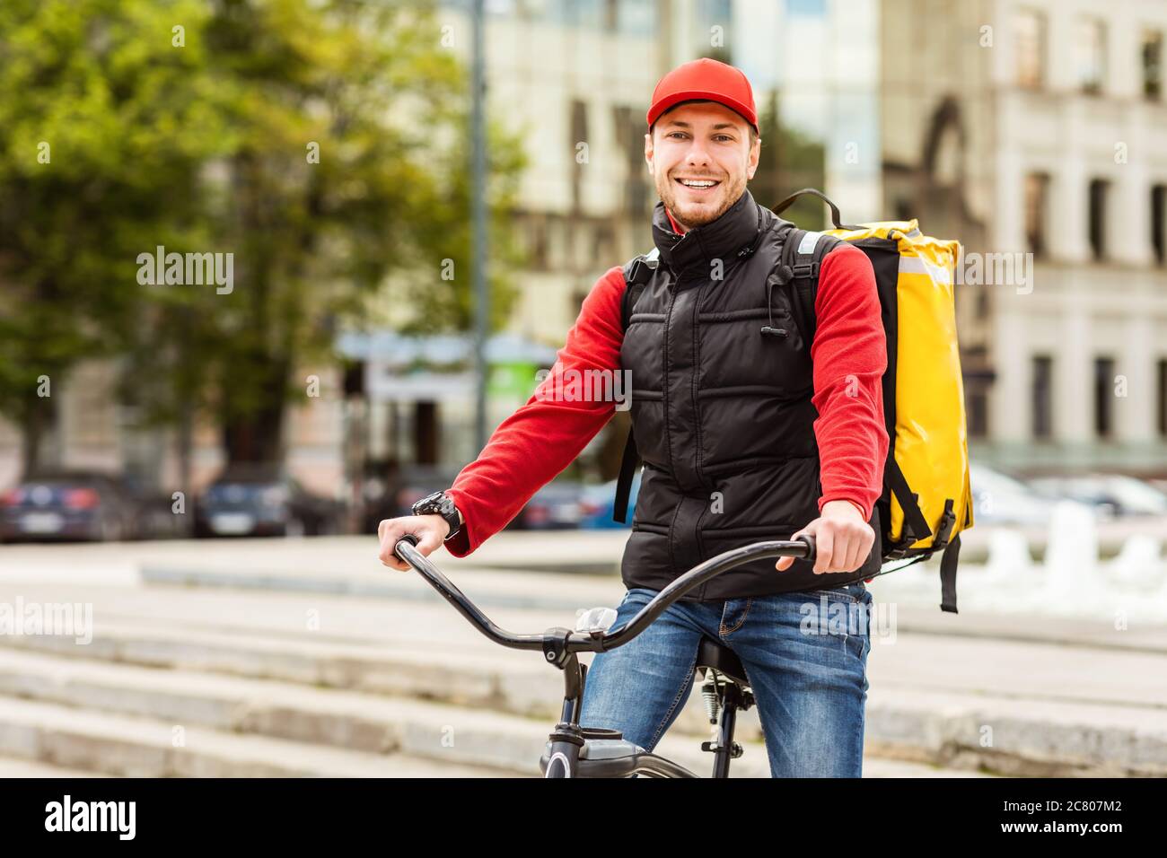 Delivery Guy Smiling To Camera Posing With Bicycle In City Stock Photo ...