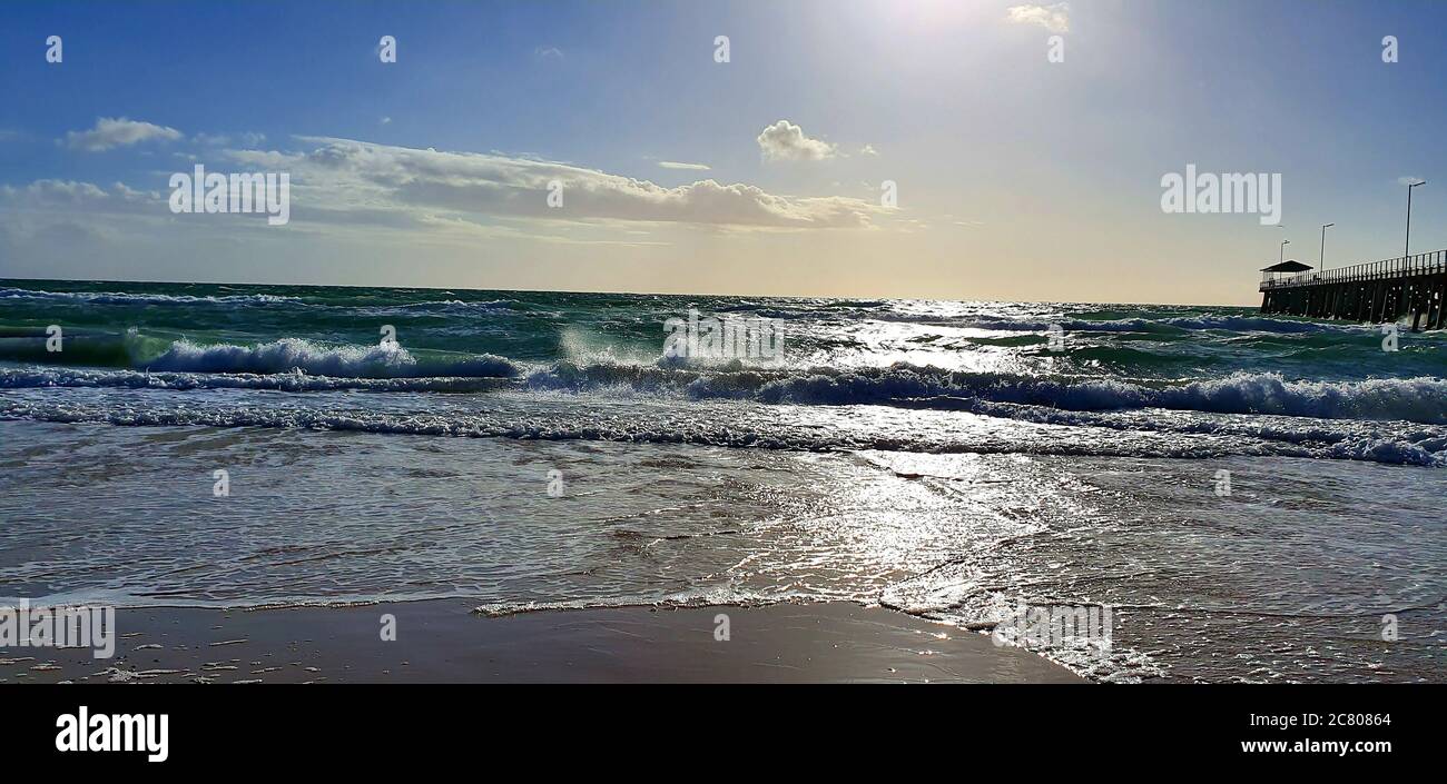 Wavy beach captured during the daytime with clouds in the sky Stock ...