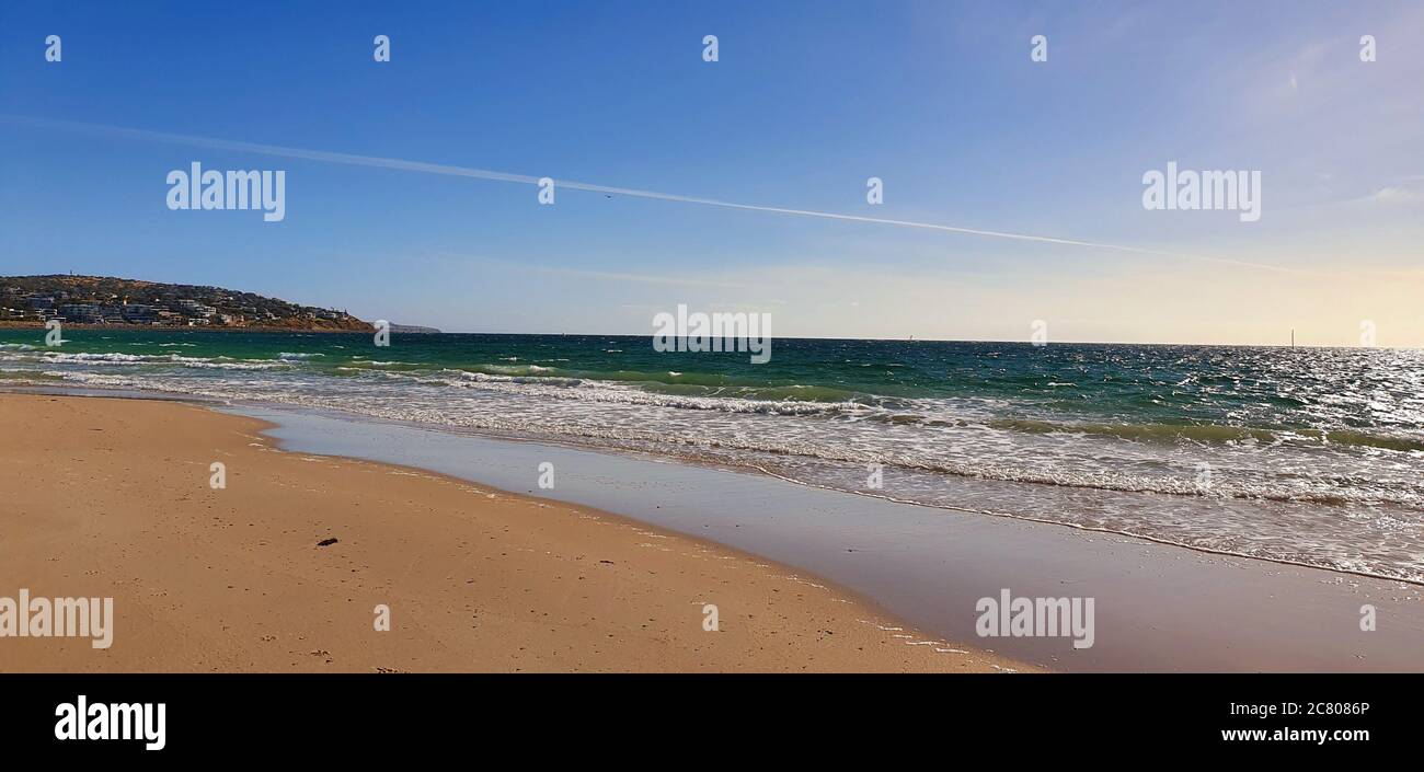 Wavy beach captured during the daytime with a clear sky Stock Photo - Alamy