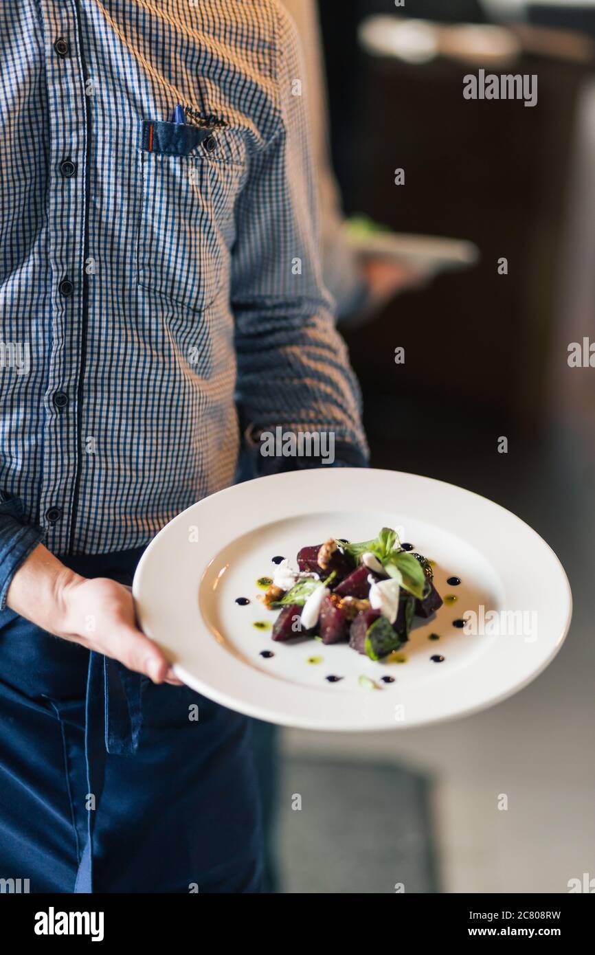 Waiter carrying three plates hi-res stock photography and images - Alamy