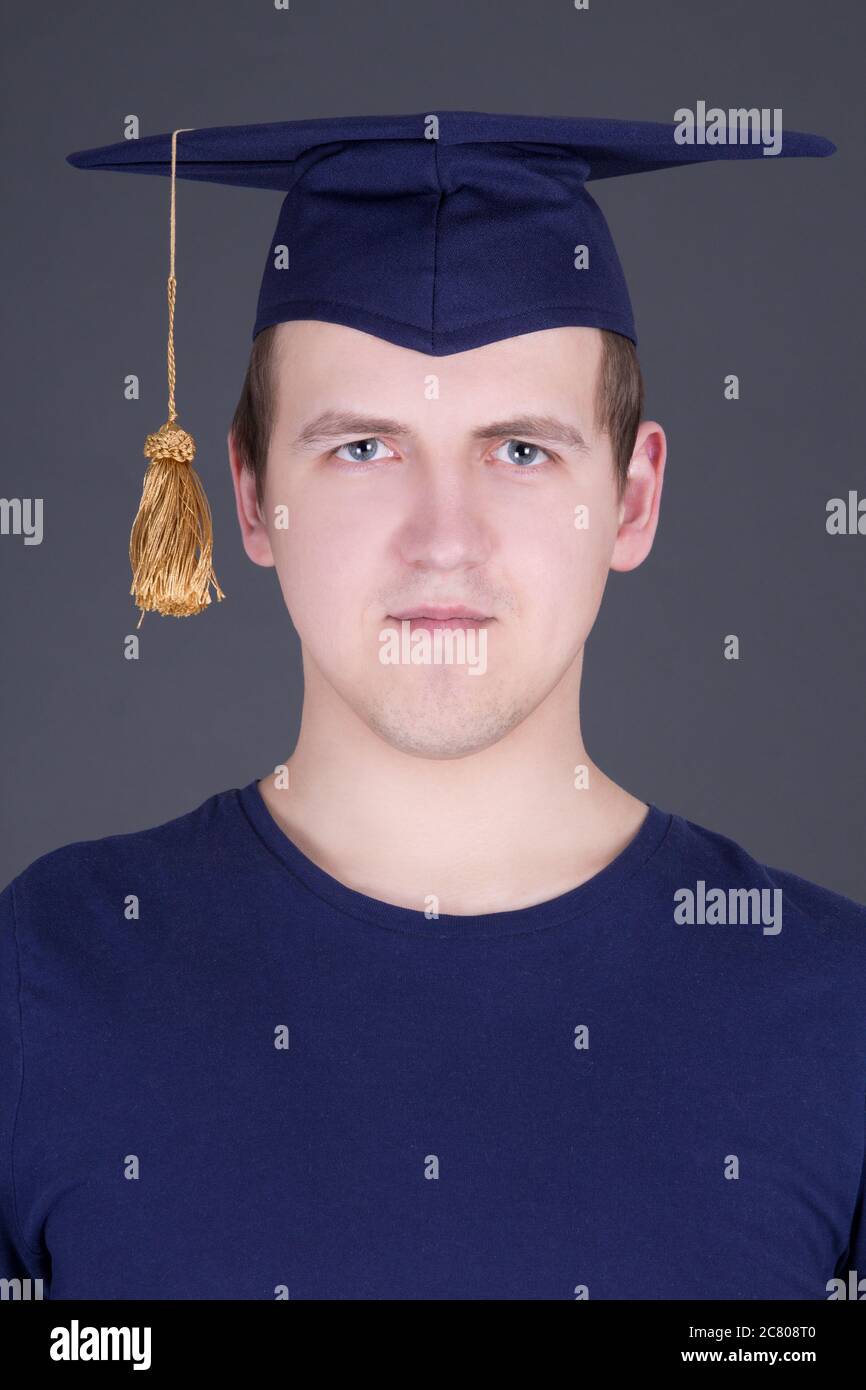 young graduation man over grey background Stock Photo - Alamy