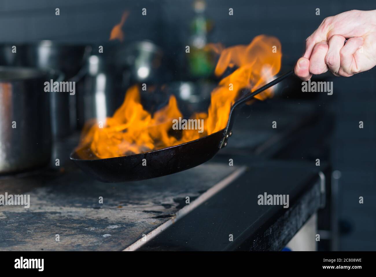 Chef is stirring vegetables in wok Stock Photo - Alamy