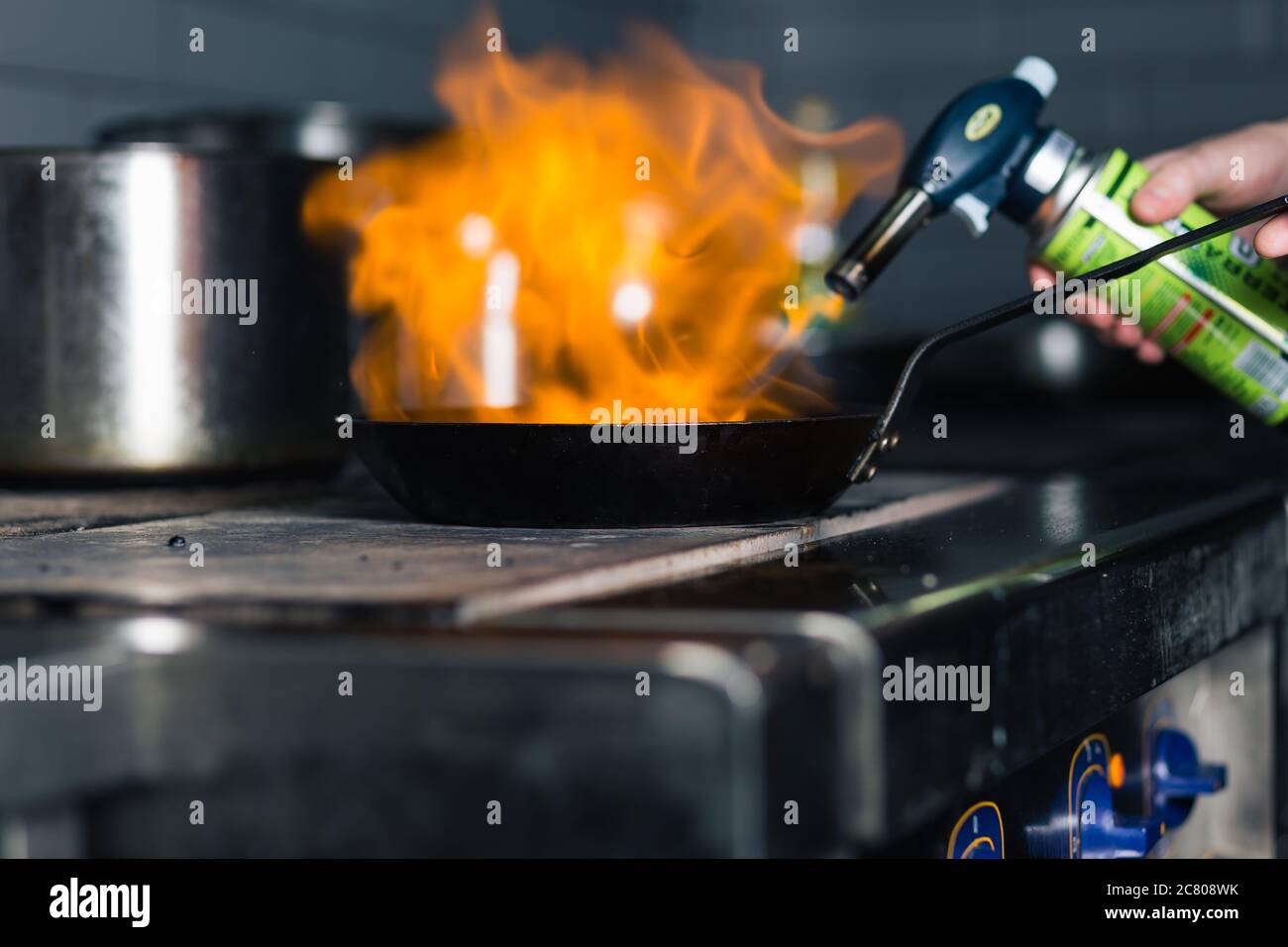 Fire burn is cooking on iron pan,stir fire very hot Stock Photo - Alamy