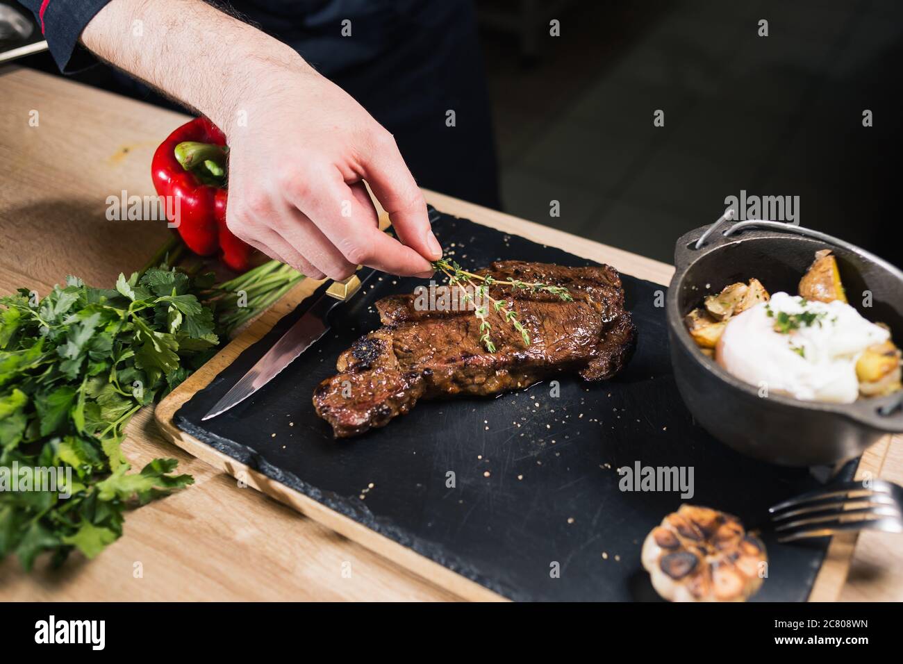 Man cooking meat steak on kitchen Stock Photo - Alamy