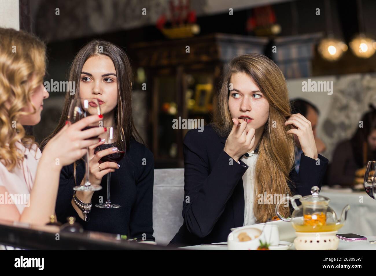 Girls having fun. Best friends hanging out and eating at restaurant ...