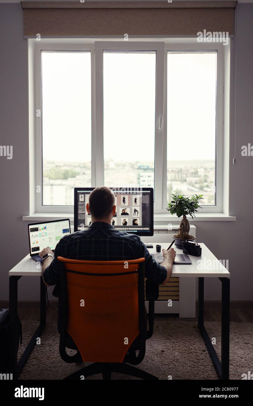 Freelancer man working remotely from home. Young male working on his ...