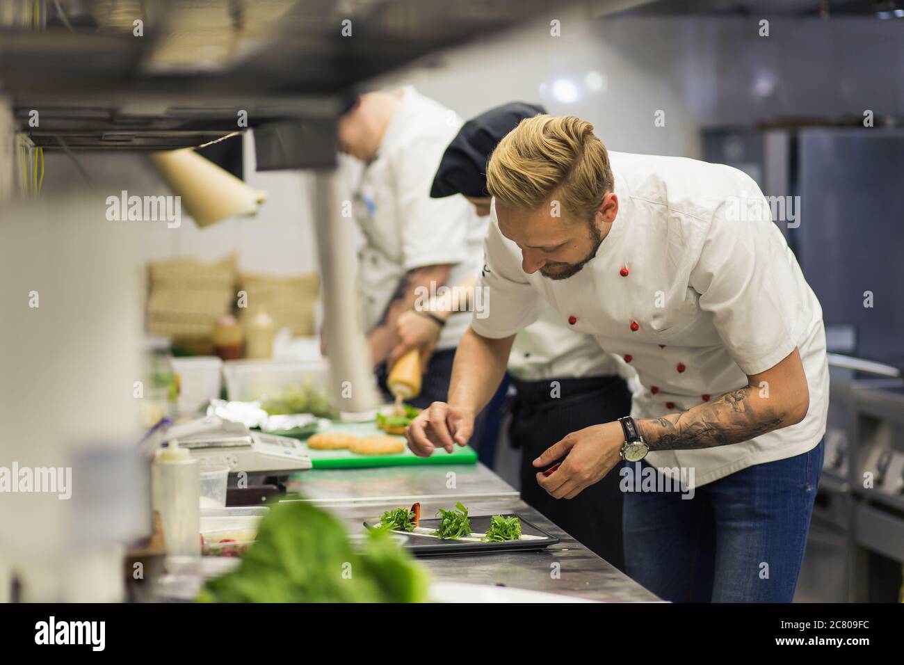 male cooks preparing meals in restaurant kitchen Stock Photo - Alamy