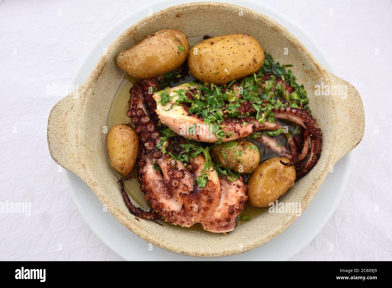 Grilled octopus with batatas a murro, or smashed potatoes and garlic in ...