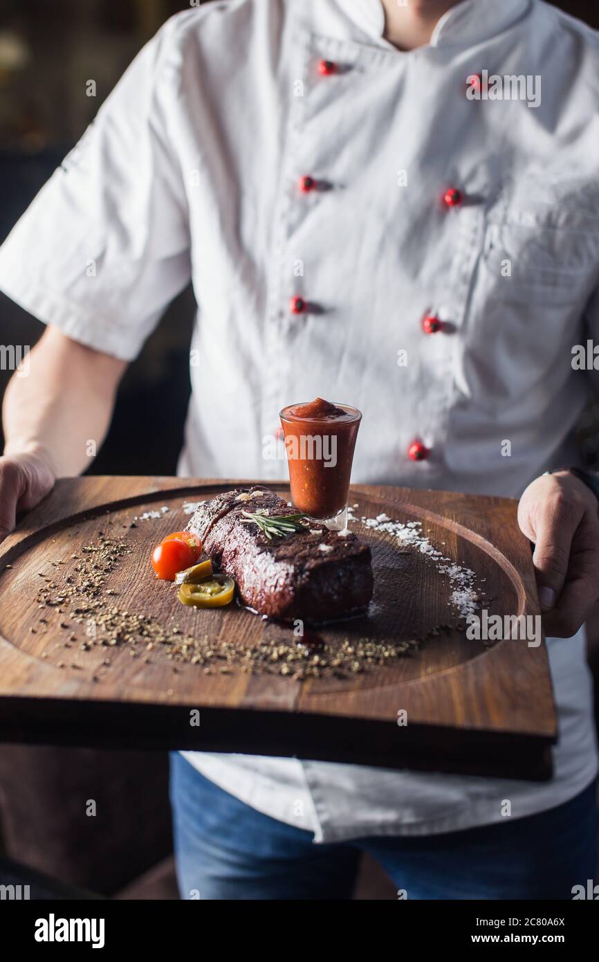 male cooks preparing meat in the restaurant kitchen Stock Photo - Alamy