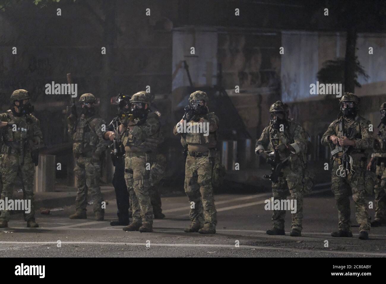 Portland, USA. 20th July, 2020. Federal officers form a line facing ...