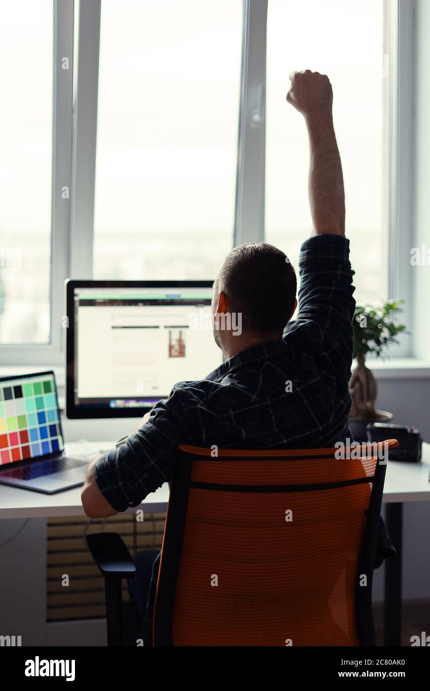 Victory, back view portrait of a successful man, who is celebrating at ...