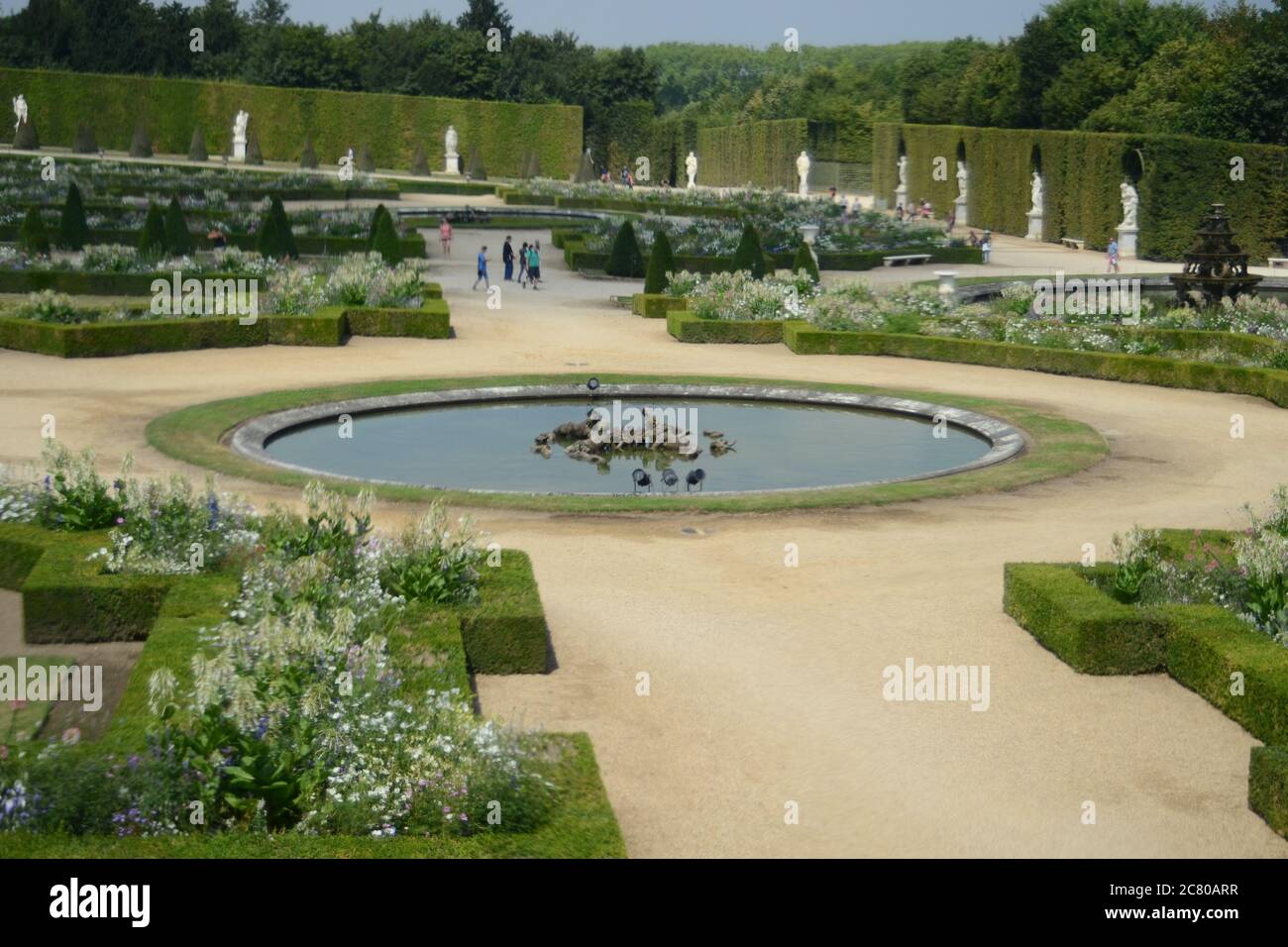 Beautiful shot of a well designed garden with statues and fountain and ...