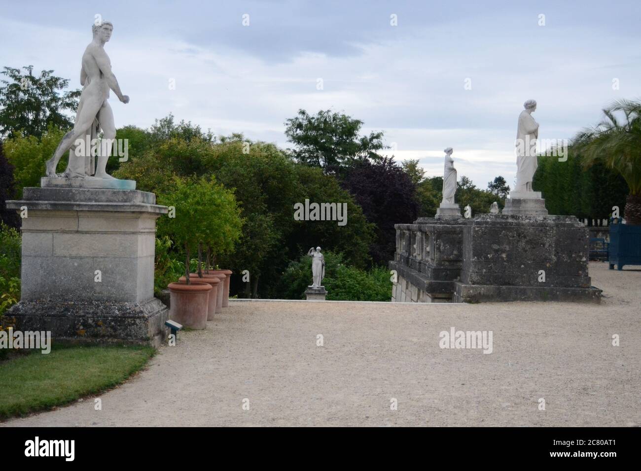 Beautiful shot of a well designed garden with statues and wide walking ...