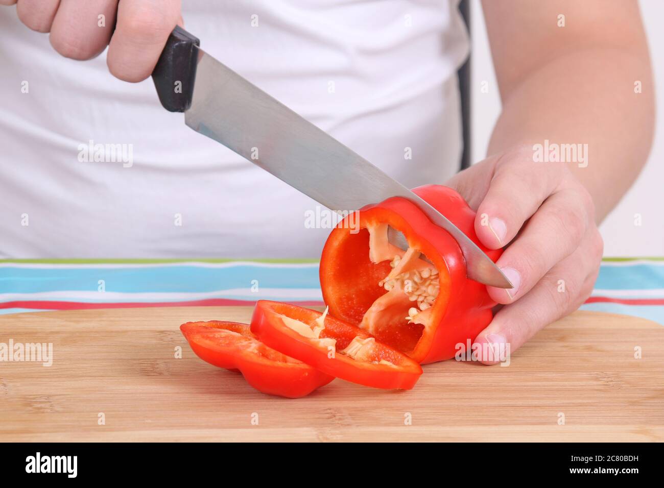 male hands cutting red pepper in the kitchen Stock Photo - Alamy