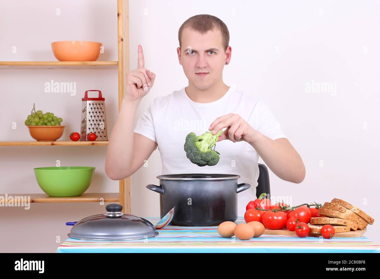 man cooking soup with broccoli in the kitchen Stock Photo - Alamy