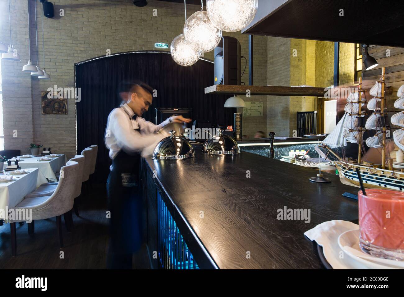 motion waiter of a restaurant interior Stock Photo - Alamy
