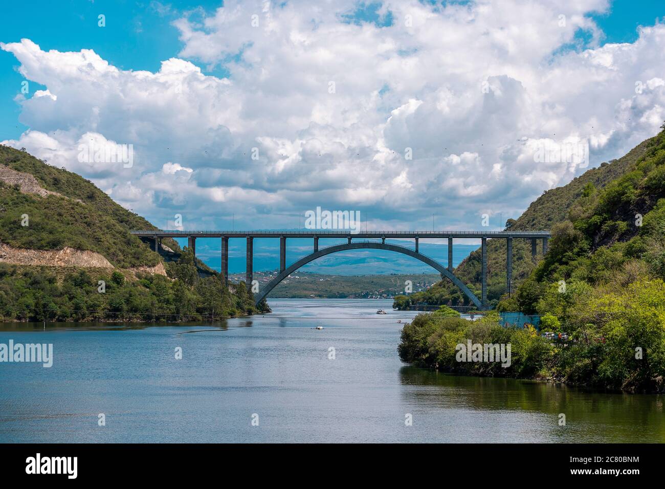Bridge between mountains over the lake Stock Photo - Alamy
