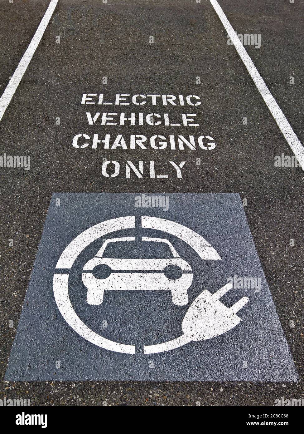 Vertical shot of an electronic vehicle charging only sign on the street ...