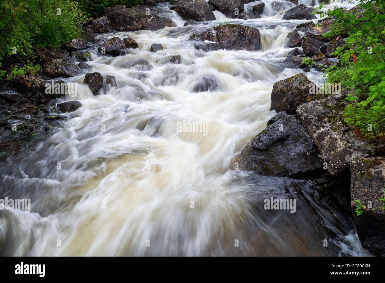 A beautiful scene of a small stream with white waters photographed in ...