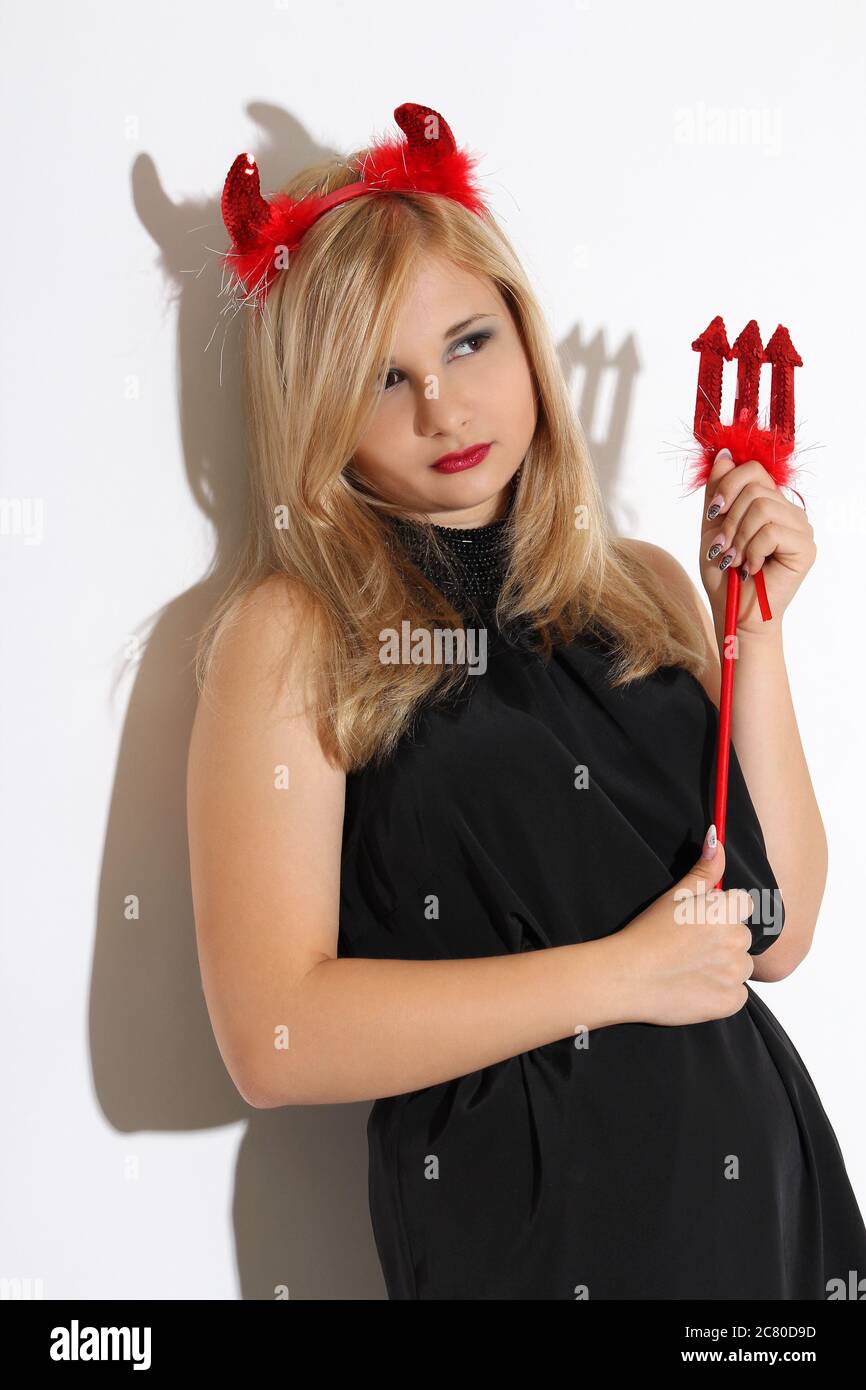 Blonde girl wearing a red costume of an imp Stock Photo - Alamy