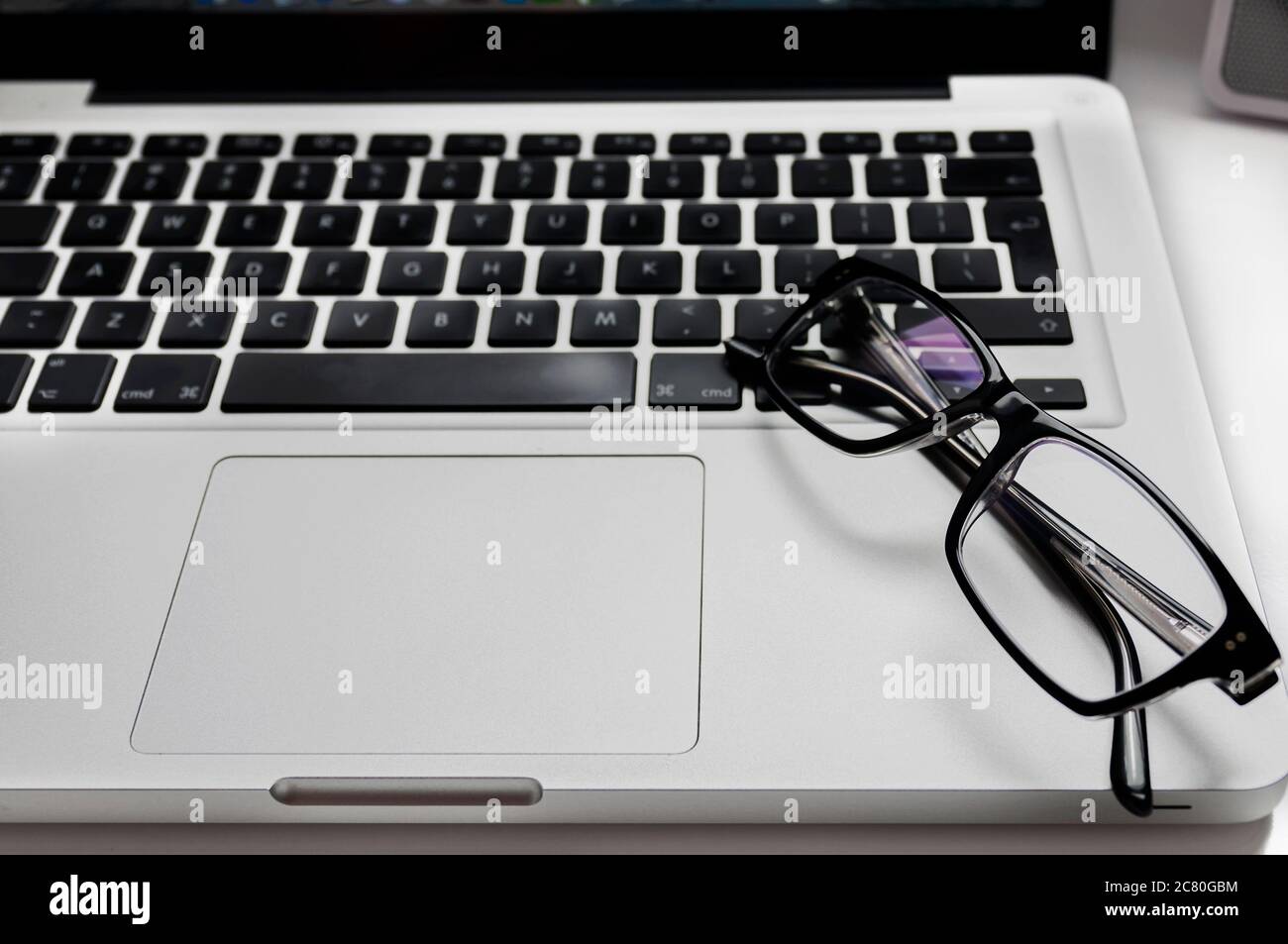 Businessman's glasses on laptop computer Stock Photo - Alamy