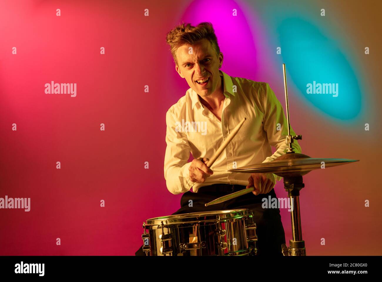 Emotions. Young caucasian inspired and expressive musician, drummer ...