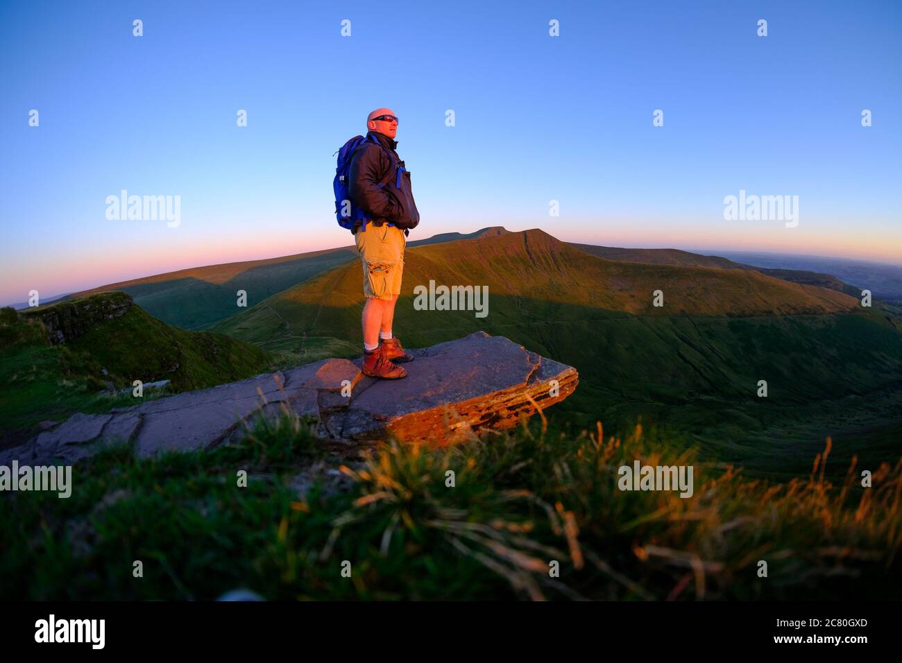 Brecon, UK. 20th July, 2020. A walker enjoys the sunrise in the Brecon ...