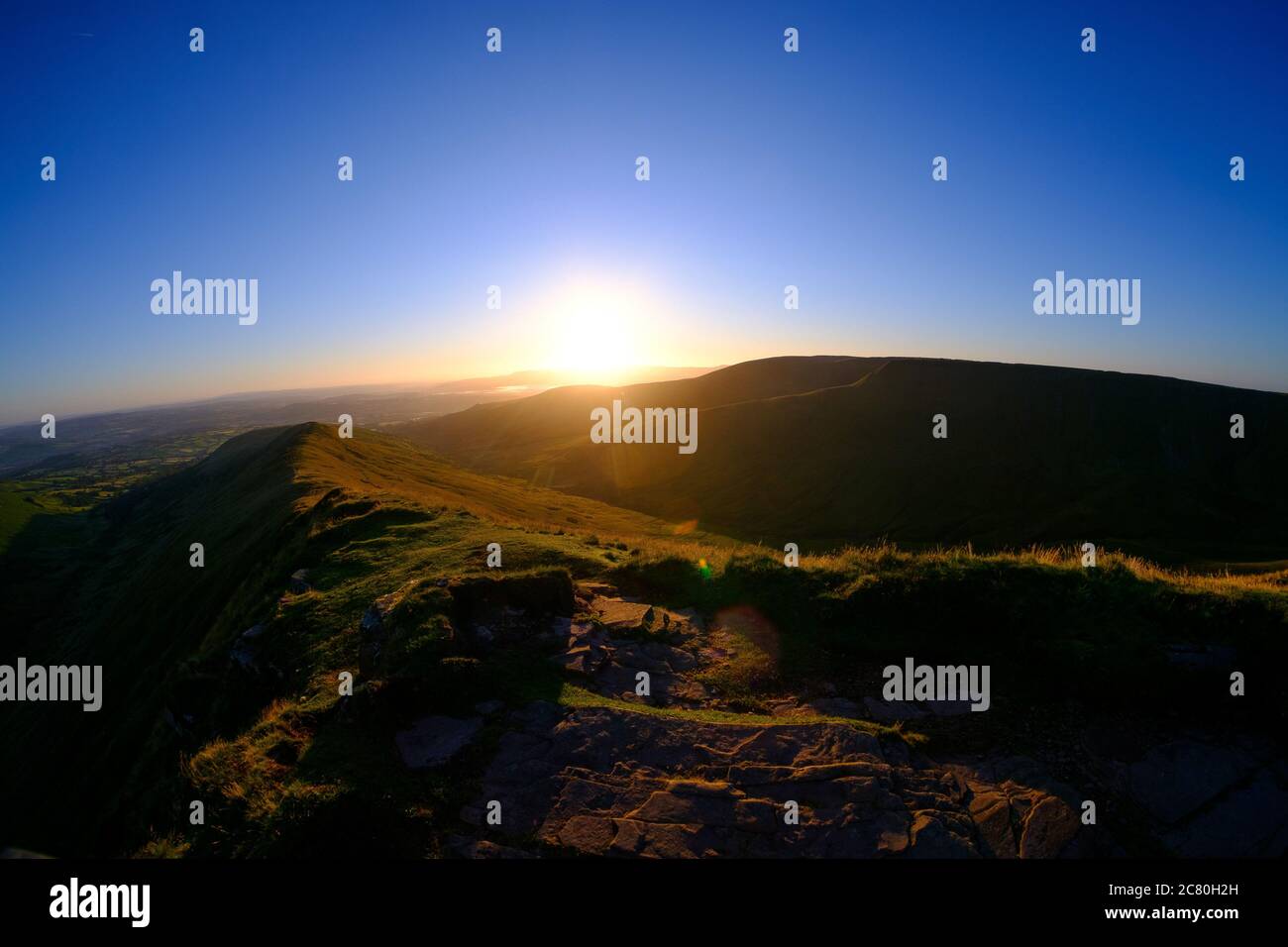 Brecon, UK. 20th July, 2020. A walker enjoys the sunrise in the Brecon ...