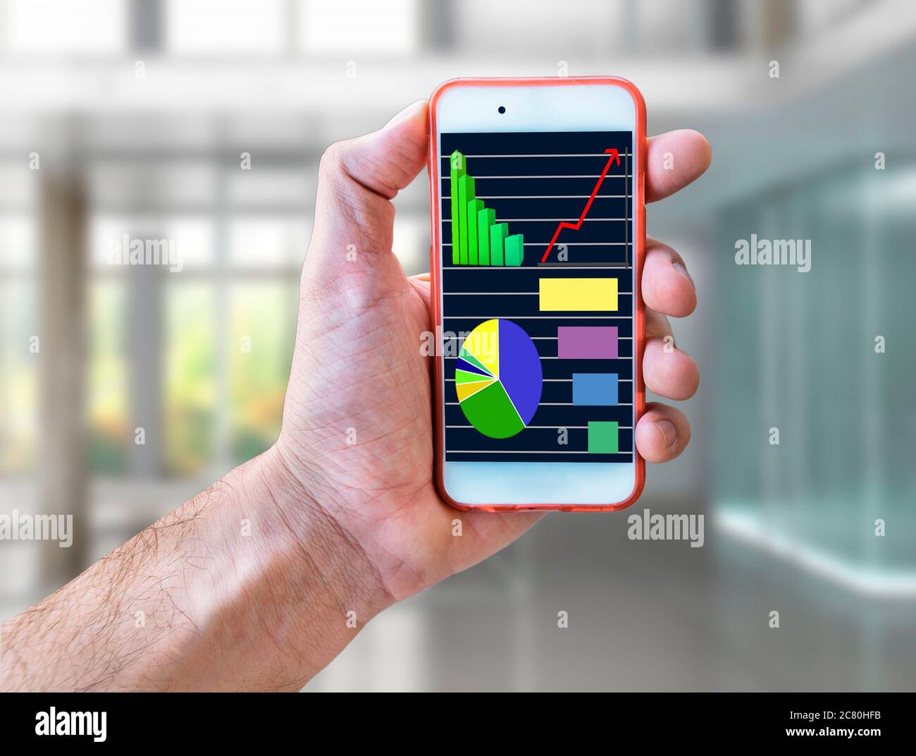 Hand holding mobile phone with analyzing graph Stock Photo - Alamy