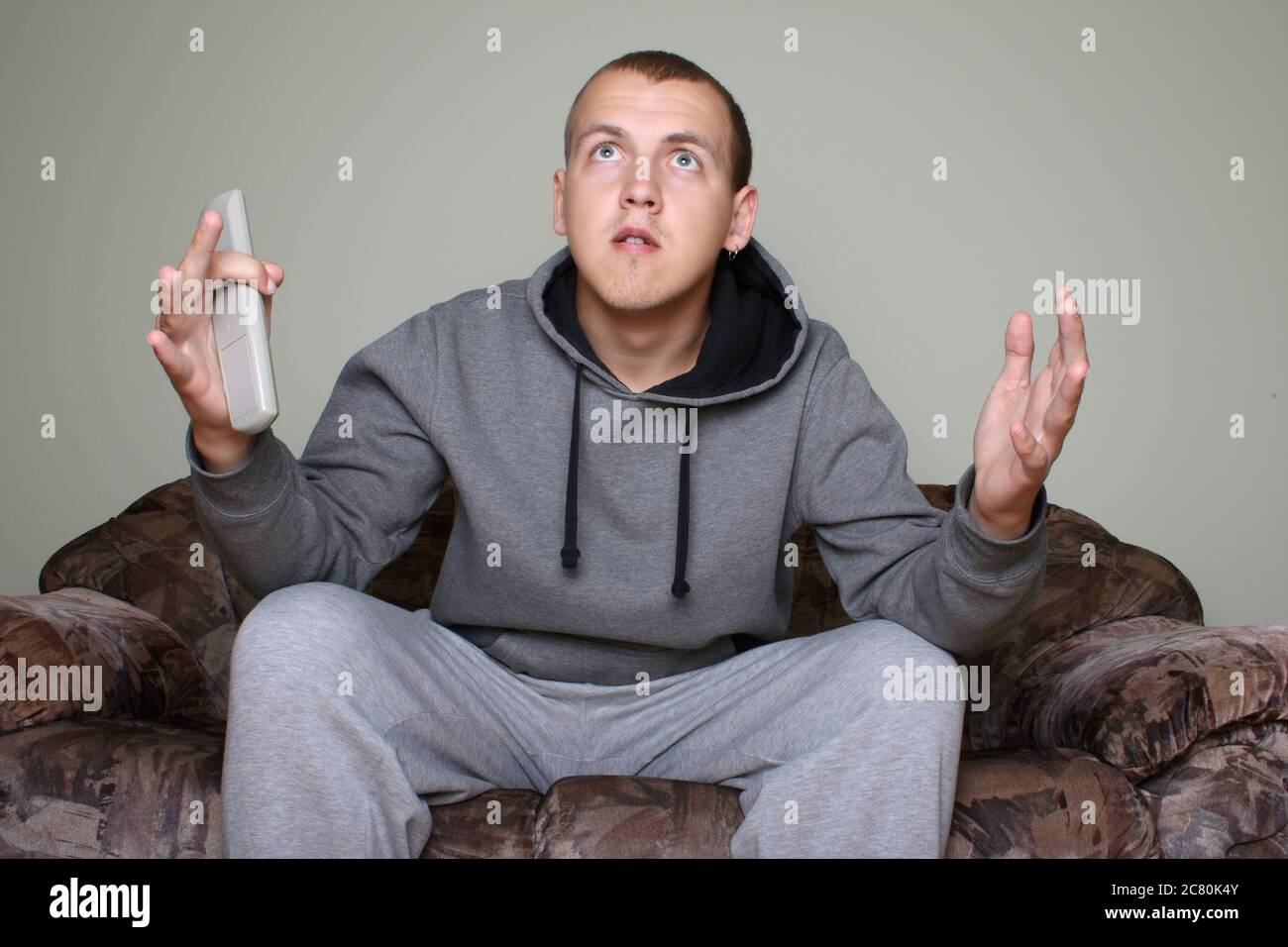 young man with remote control Stock Photo - Alamy