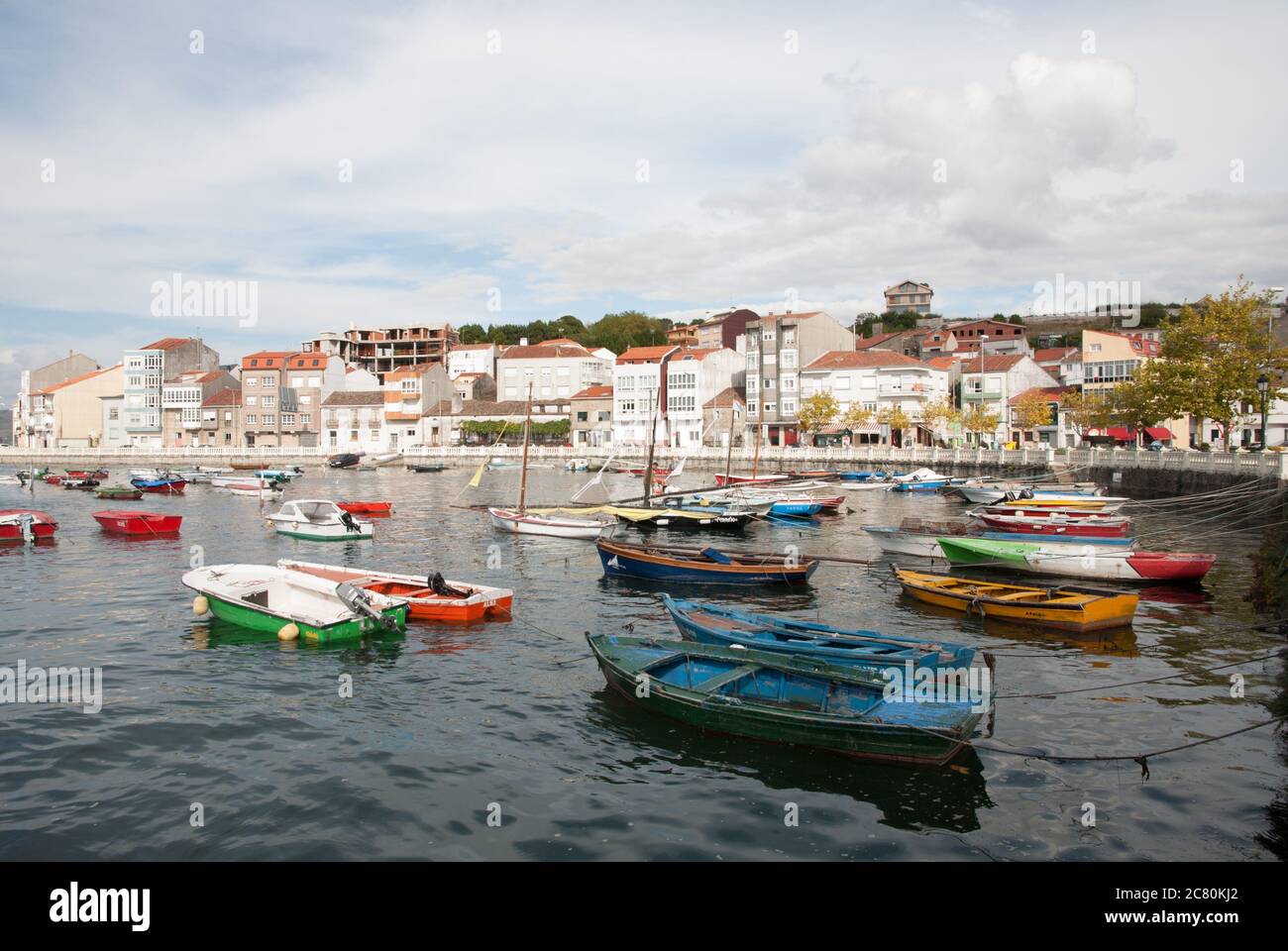 Boats on the water in front of the buildings of the city Stock Photo ...