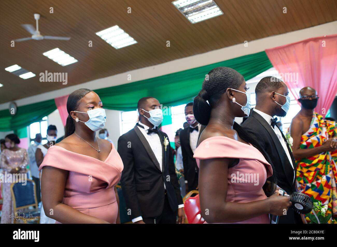 A wedding ceremony held with social distancing and people wearing mask ...