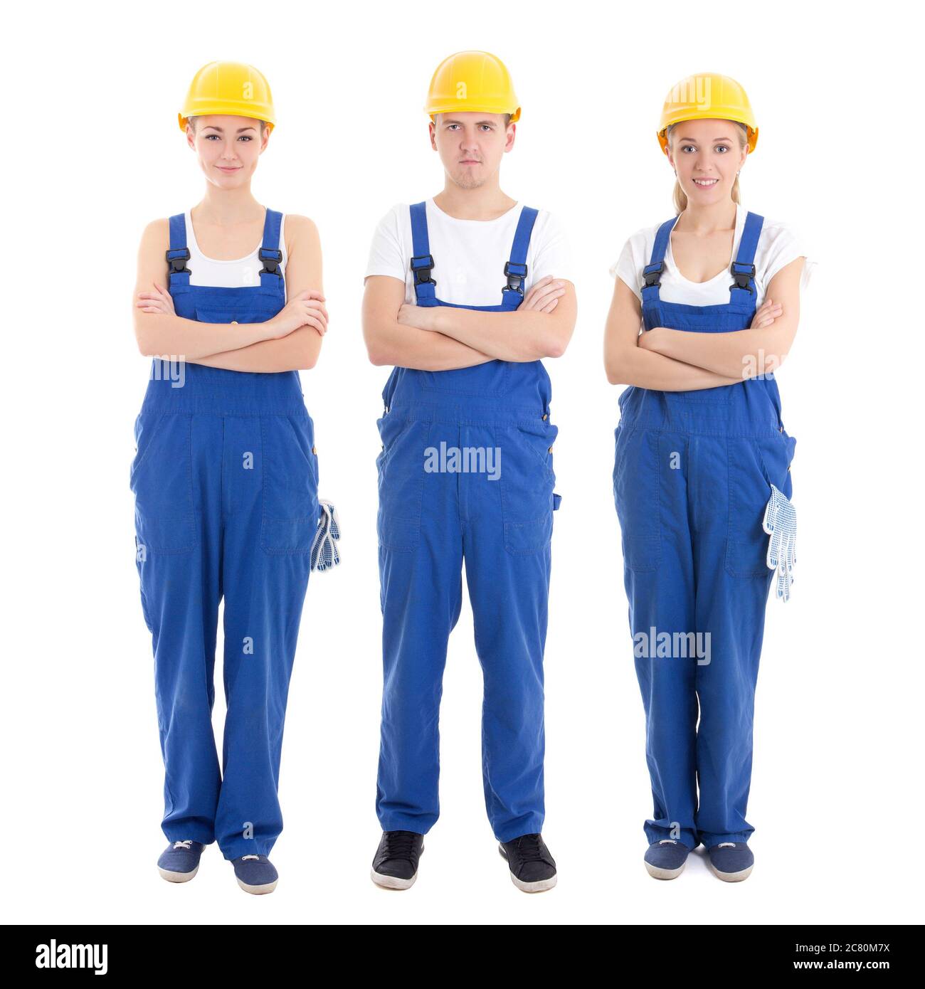 team work concept - man and two women in builders uniform isolated on ...