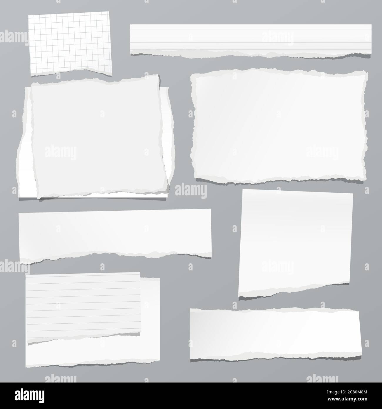 Torn of white note, notebook paper strips and pieces stuck on grey ...