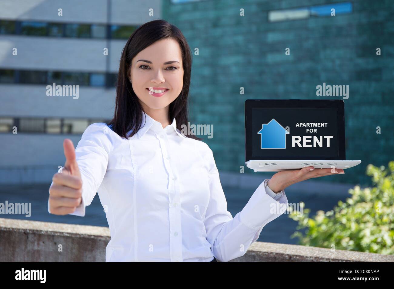 beautiful business woman showing laptop with real estate application on ...
