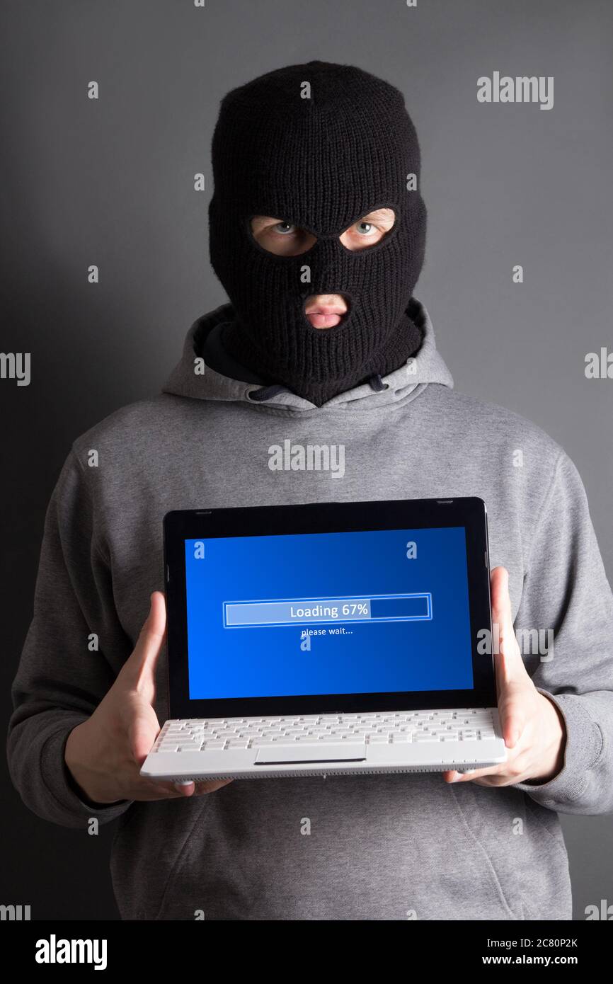 masked hacker with loading computer over grey Stock Photo - Alamy