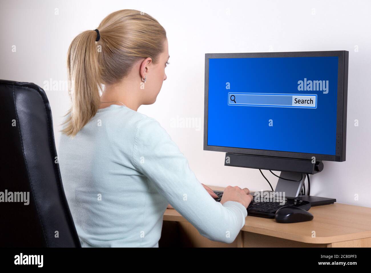 back view of woman searching something in internet with personal ...