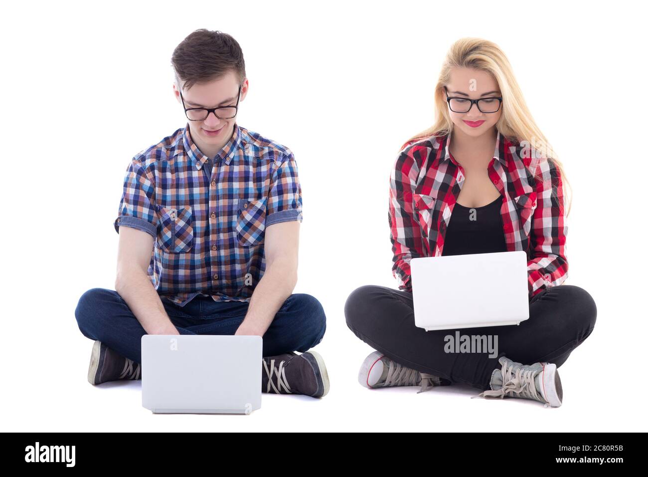 teenage girl and boy sitting with laptops isolated on white background ...