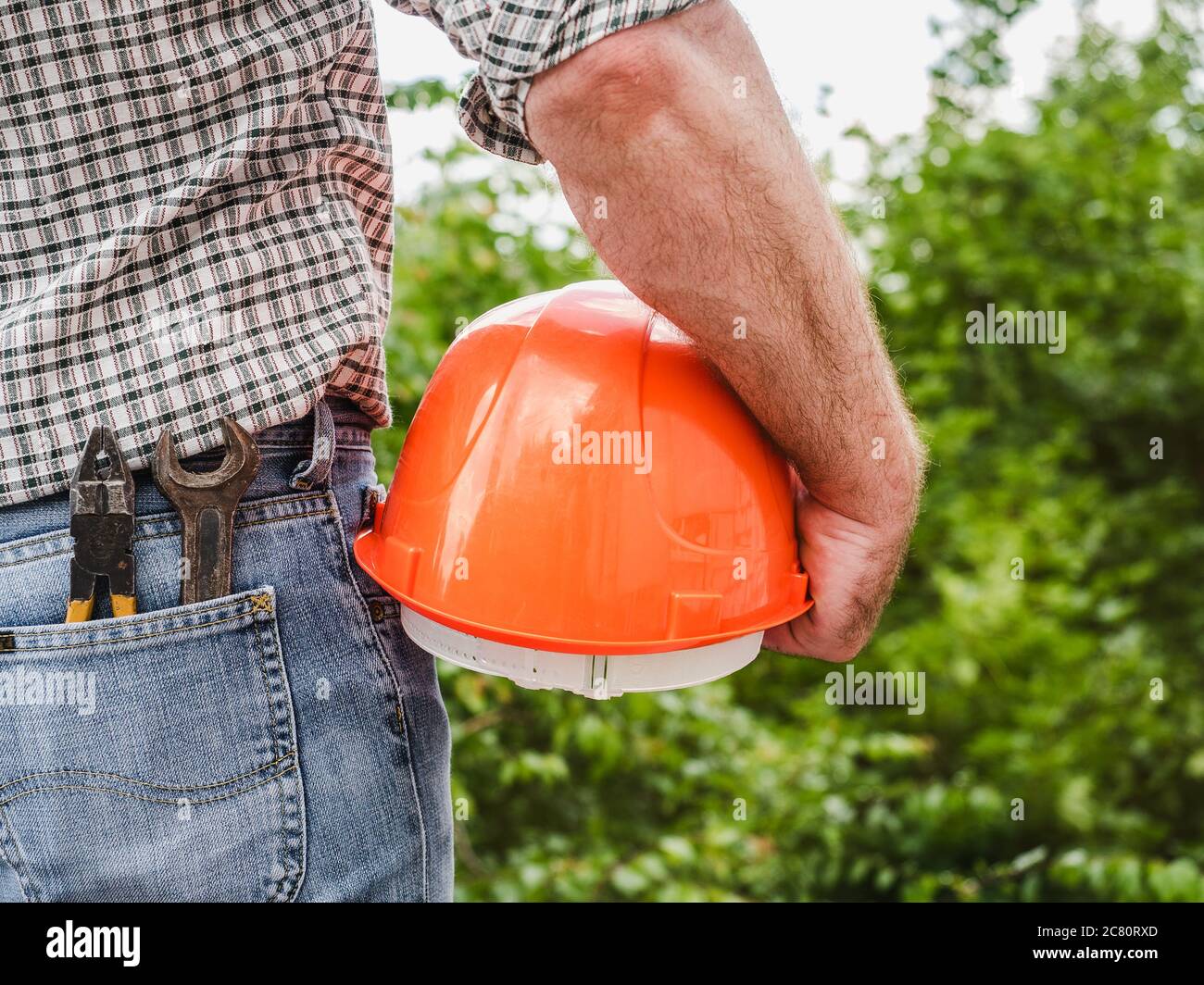 Man with tools, holding a safety helmet Stock Photo - Alamy