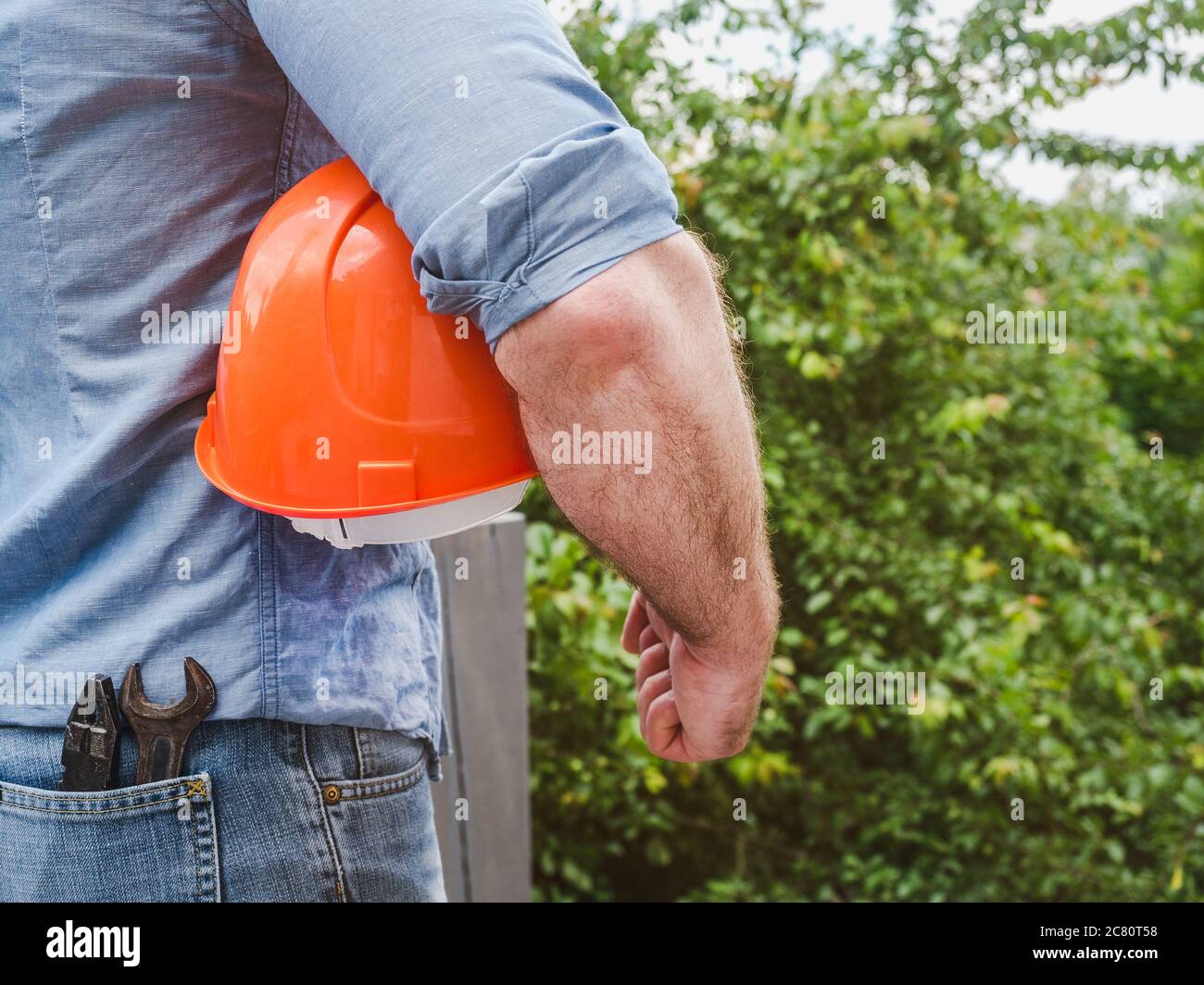 Man with tools, holding a safety helmet Stock Photo - Alamy